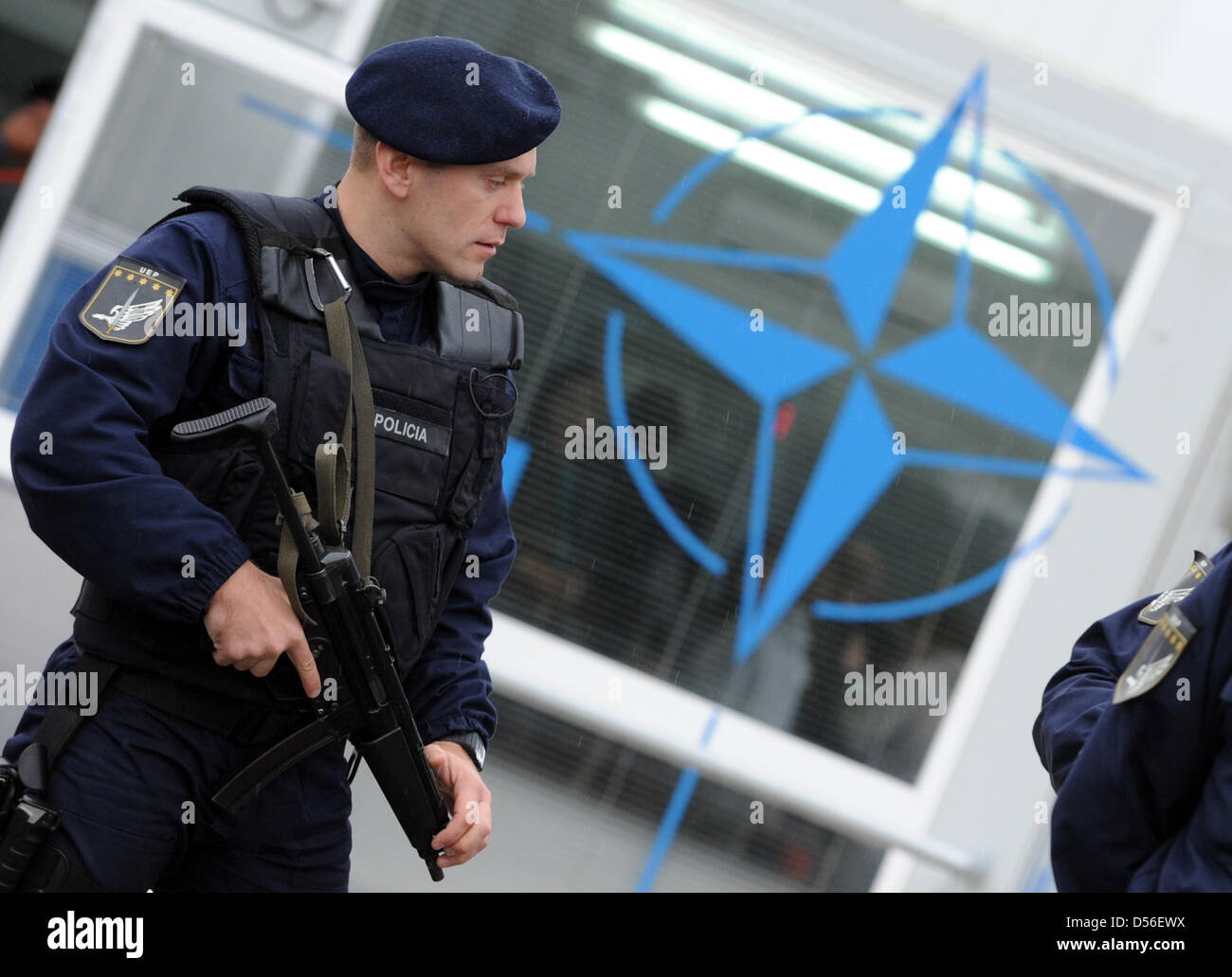 Police officers monitor the premises of the NATO Summit in Lisbon ...