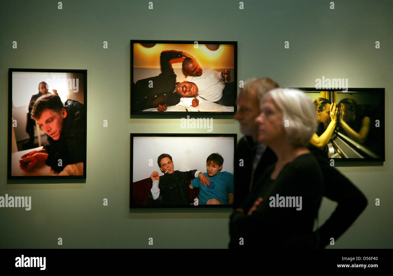 Two visitors look at photographs by the American photographer Nan ...