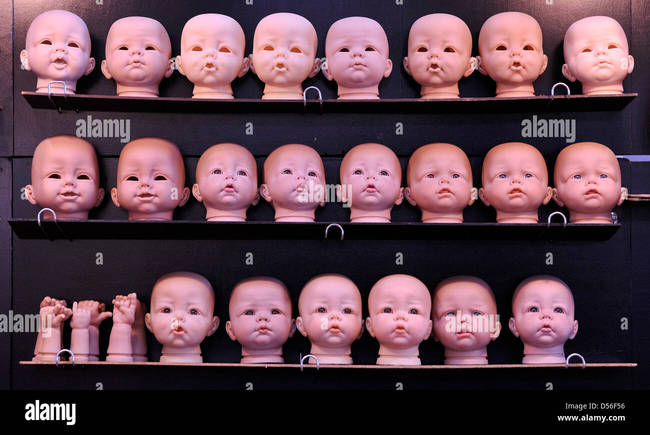 Doll heads and arms are rowed up in a sideboard at the toy exhibition ...