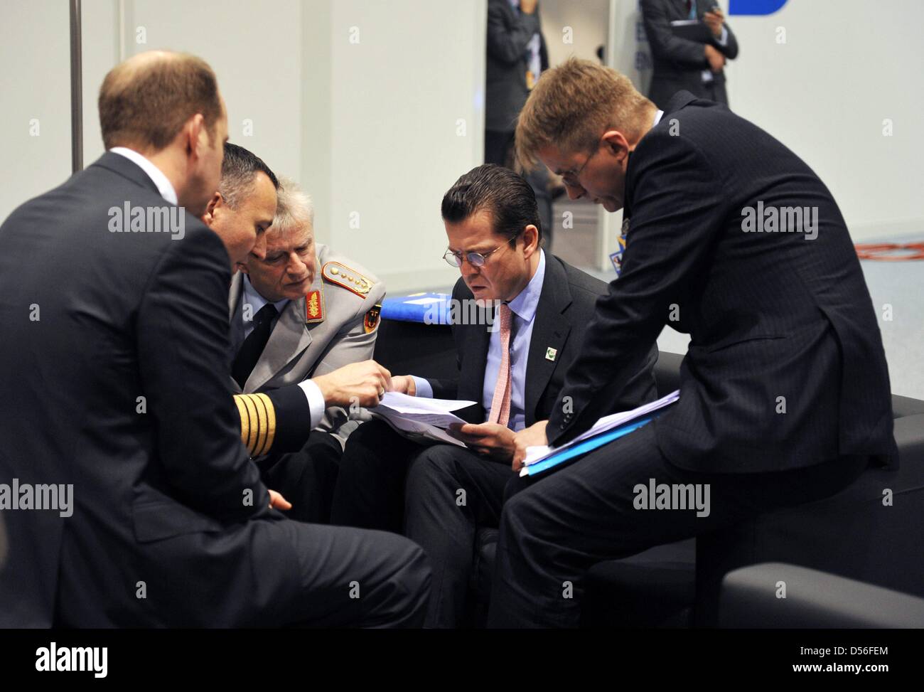 German Defence Minister Karl-Theodor zu Guttenberg (2-R) sits together ...