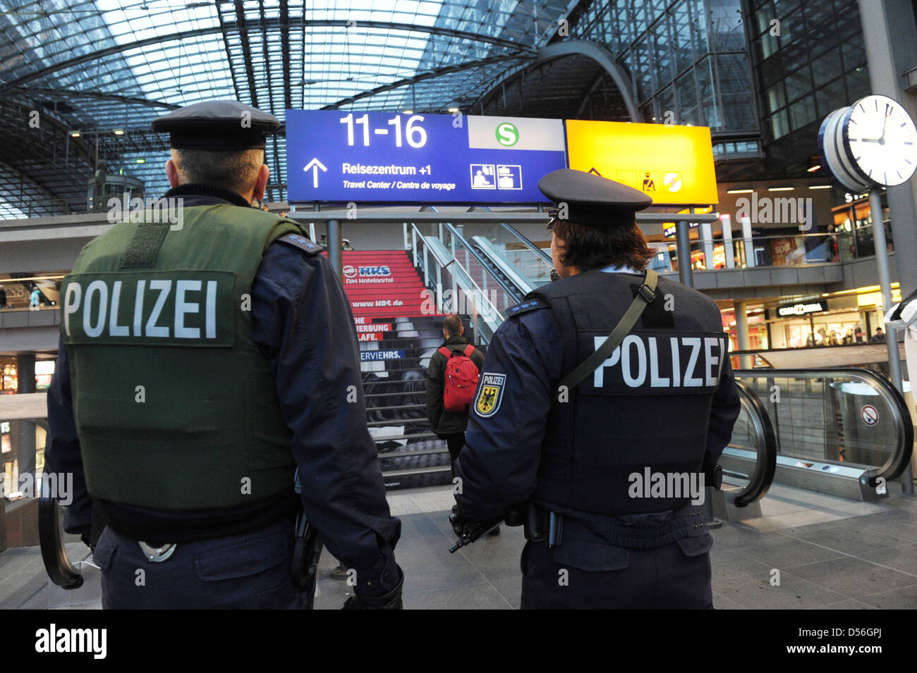 Police officers with machine guns patrol at the central station in ...