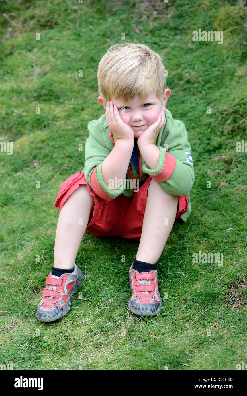 little boy resting on a walk in the countryside Stock Photo - Alamy