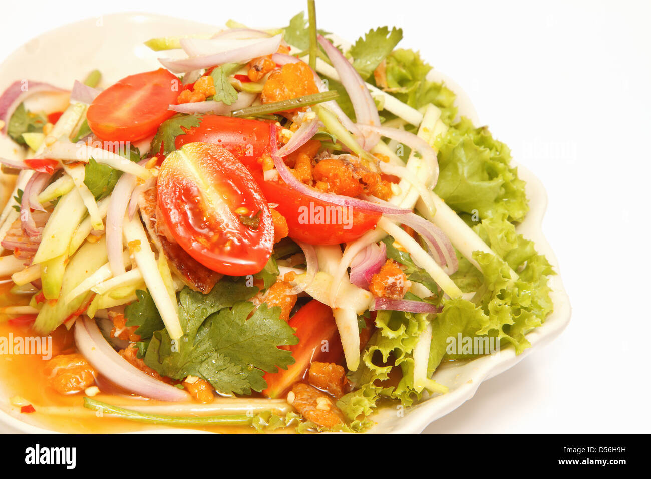 spicy crab's roe with mango salad on white background Stock Photo - Alamy
