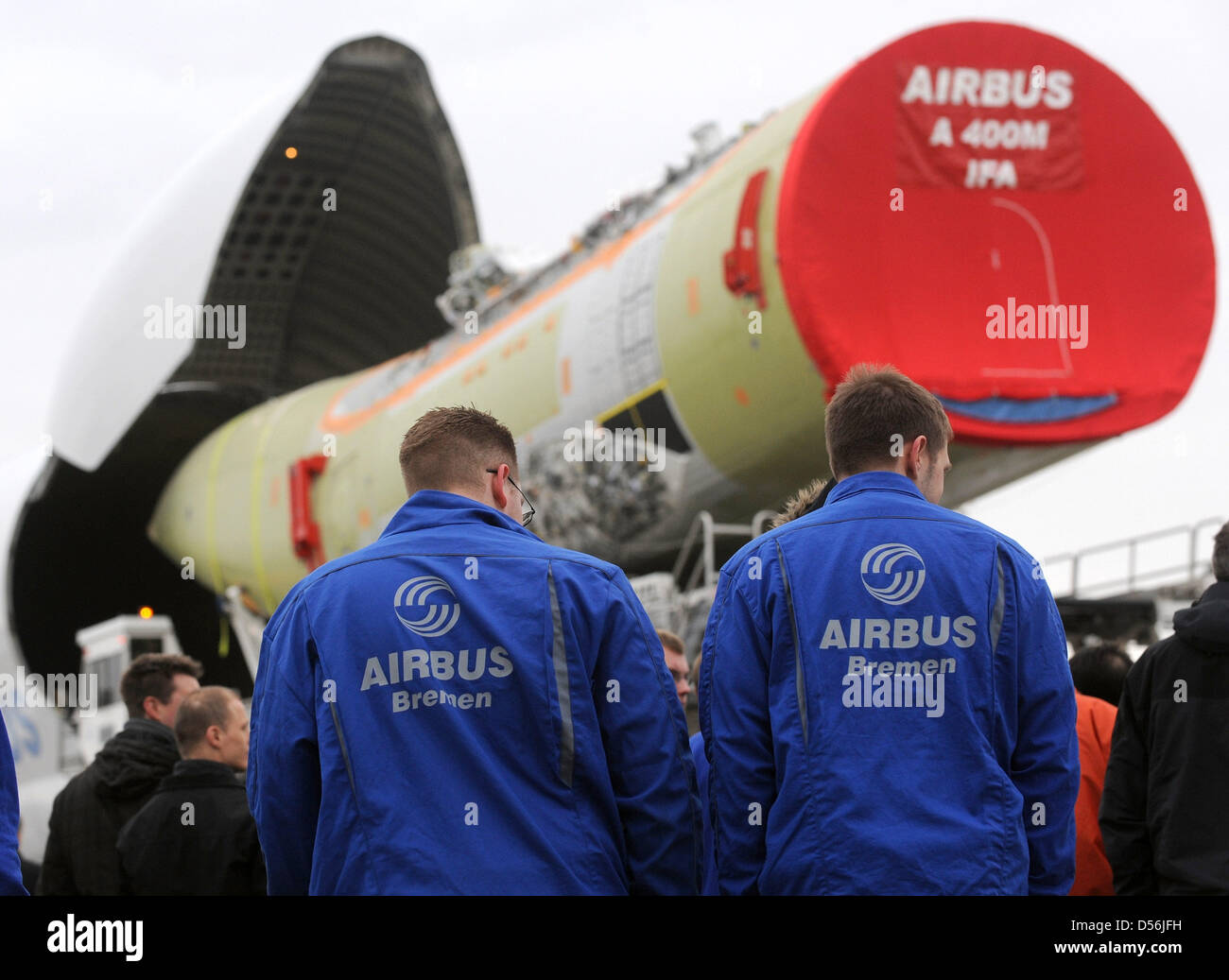 Several hundreds of Airbus employees watch as the fourth body section ...