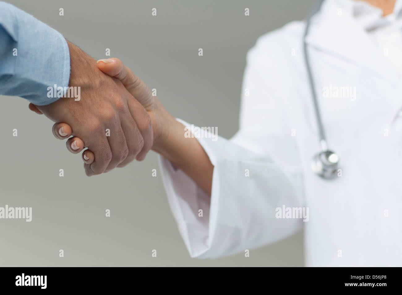 Doctor shaking patient's hand, cropped Stock Photo - Alamy