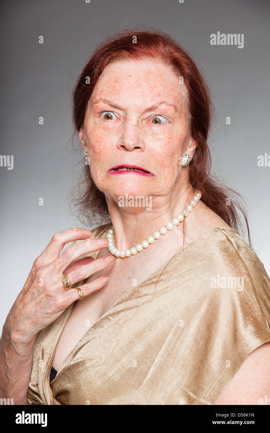 Portrait of good looking senior woman with expressive face showing ...