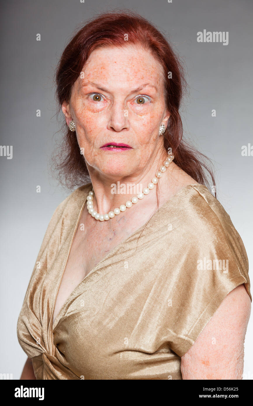 Portrait of good looking senior woman with expressive face showing ...