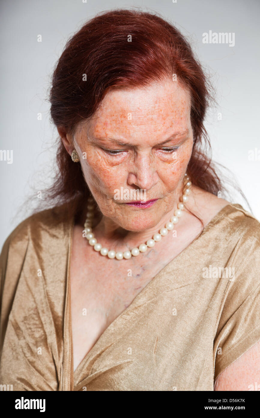 Portrait of good looking senior woman with expressive face showing ...