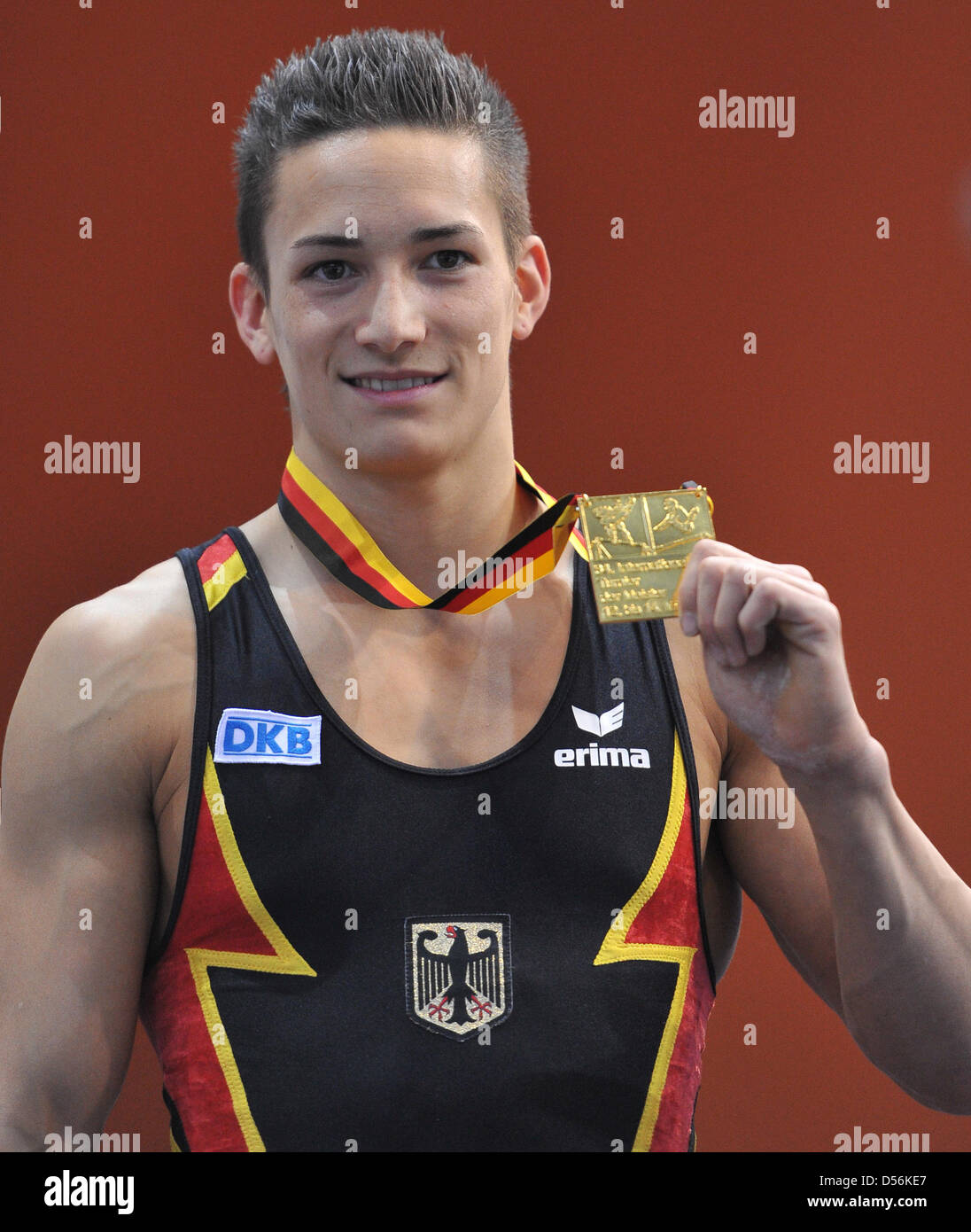 Germany's gymnast Marcel Nguyen shows his gold medal during the Men's ...