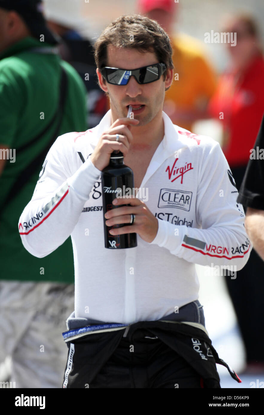 Timo Glock of 'Virgin Racing' team walks through the pit lane during ...
