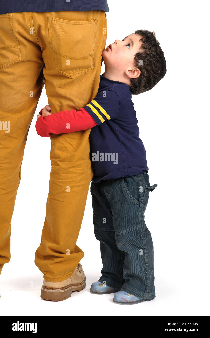 Young boy hugging his father's leg Stock Photo - Alamy