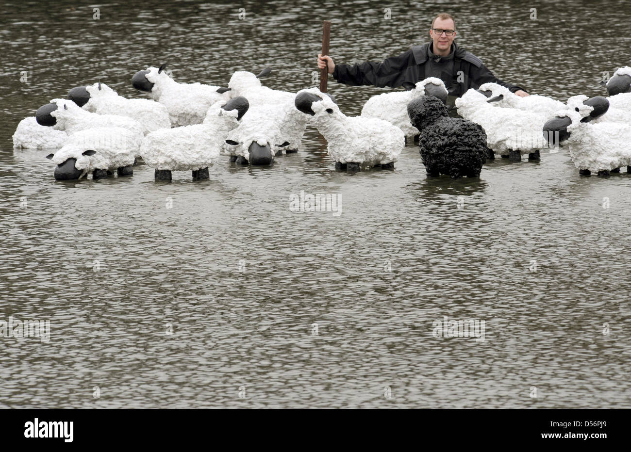 Sculptor Jens-Uwe Scholz poses with 30 so-called 'pond sheep' in Masch ...