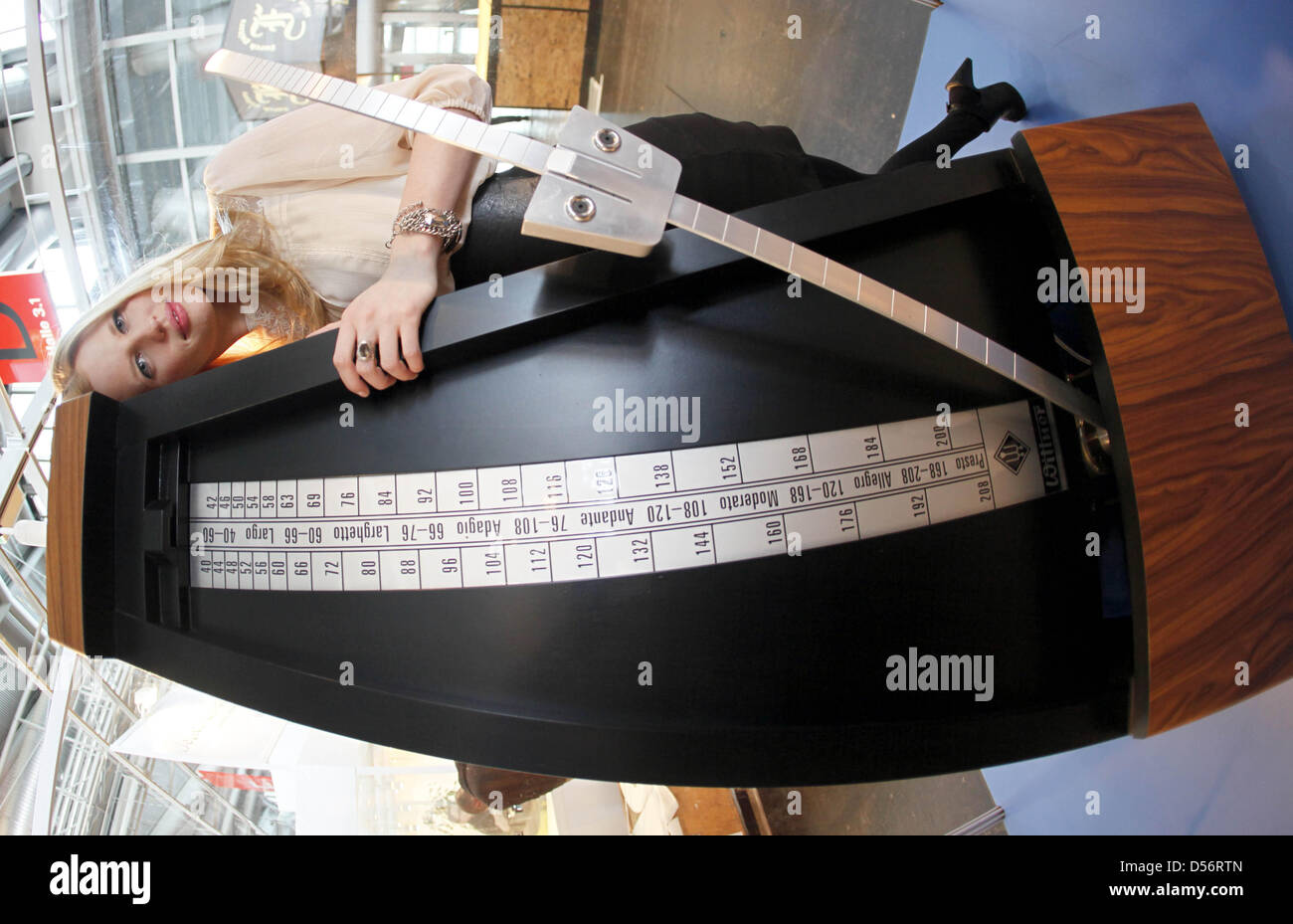 Model Clara poses with a huge metronome by producer 'Wittner' at the ...