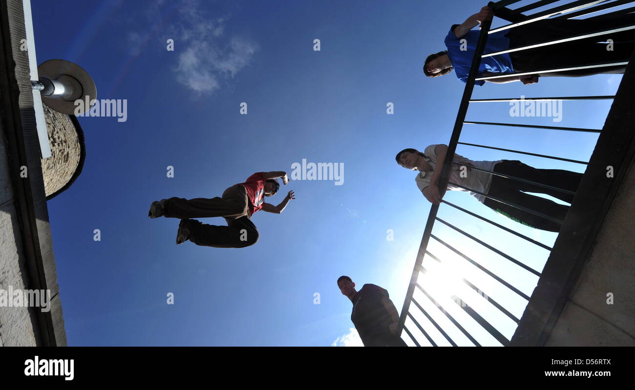 A group of traceurs train their jumps at friedly conditions in Hanover ...