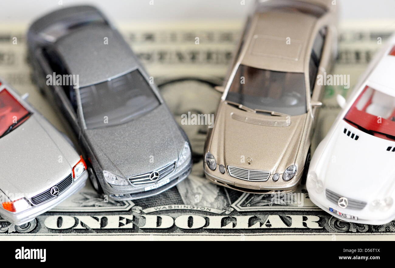 ILLUSTRATION - Mercedes models stand on a Dollar bill in Hamburg ...