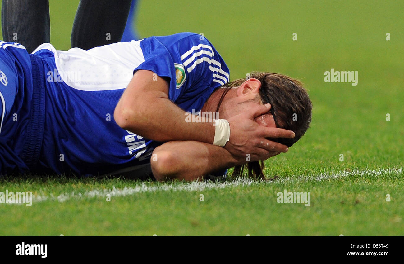 Schalke's Marcelo Bordon covers his face with his hands during the German DFB Cup semi-final ...