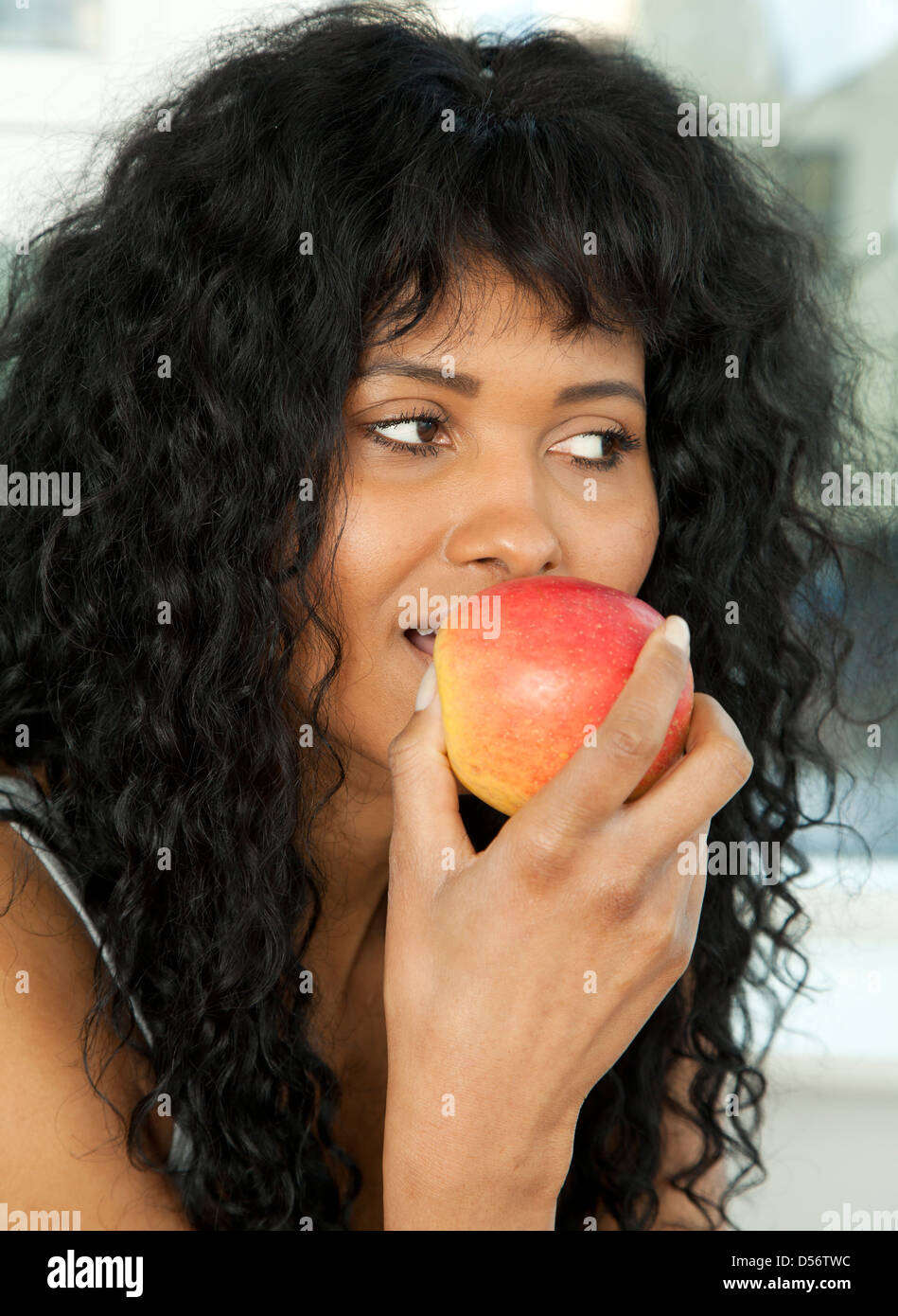 Attractive young woman eating an apple Stock Photo - Alamy