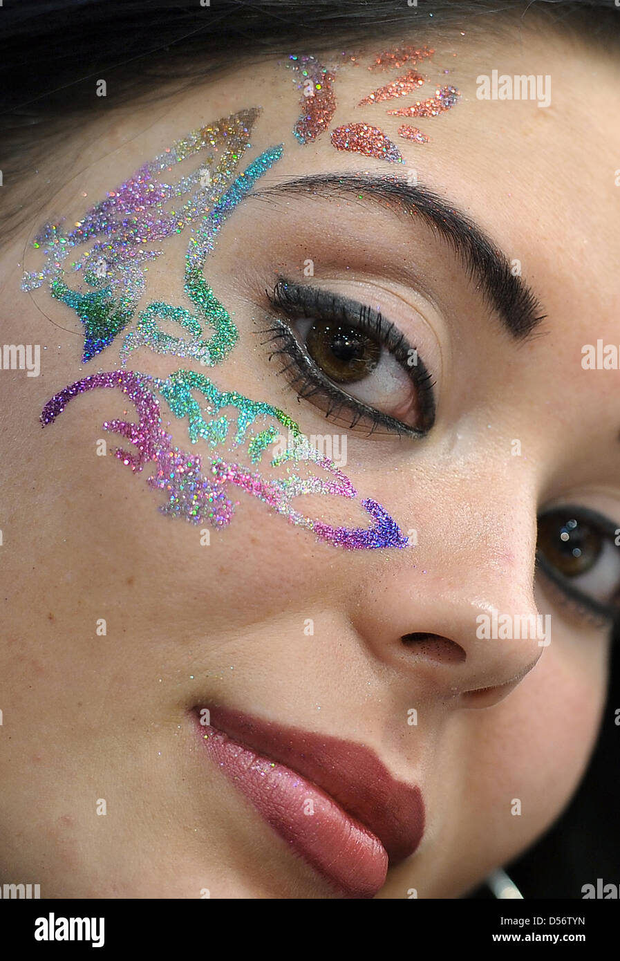 A model presents a glitter tattoo at Beauty International trade show in ...