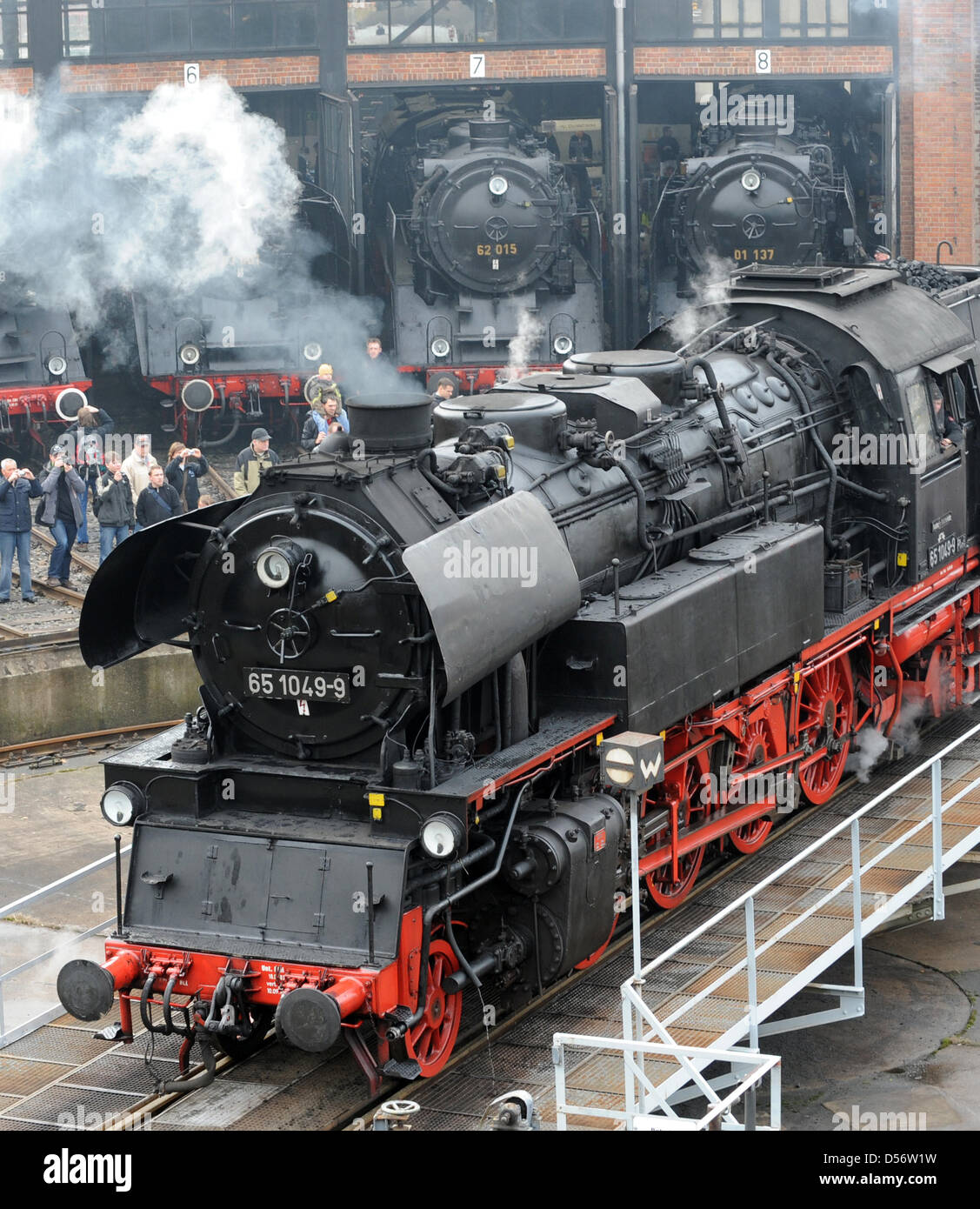 A locomotive type 65 wheezes steam on a locomotive turntable at the ...