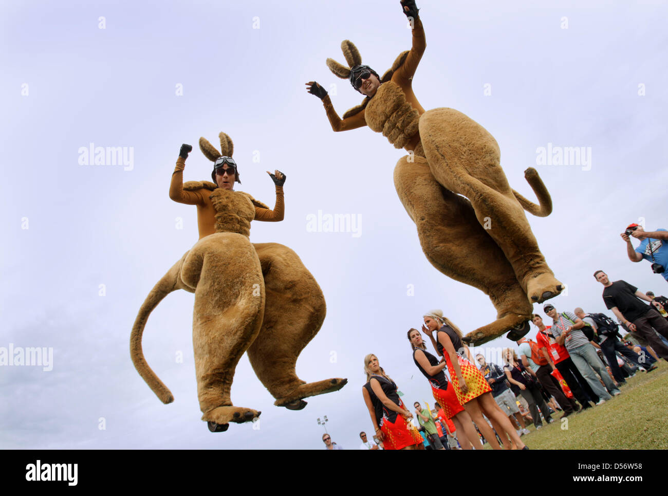Two men have dressed up as kangaroos and jump into the air in the area ...