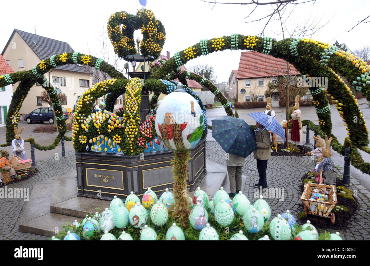 Tourists eye a traditional Easter fountain ornamented with 9,200 eggs ...