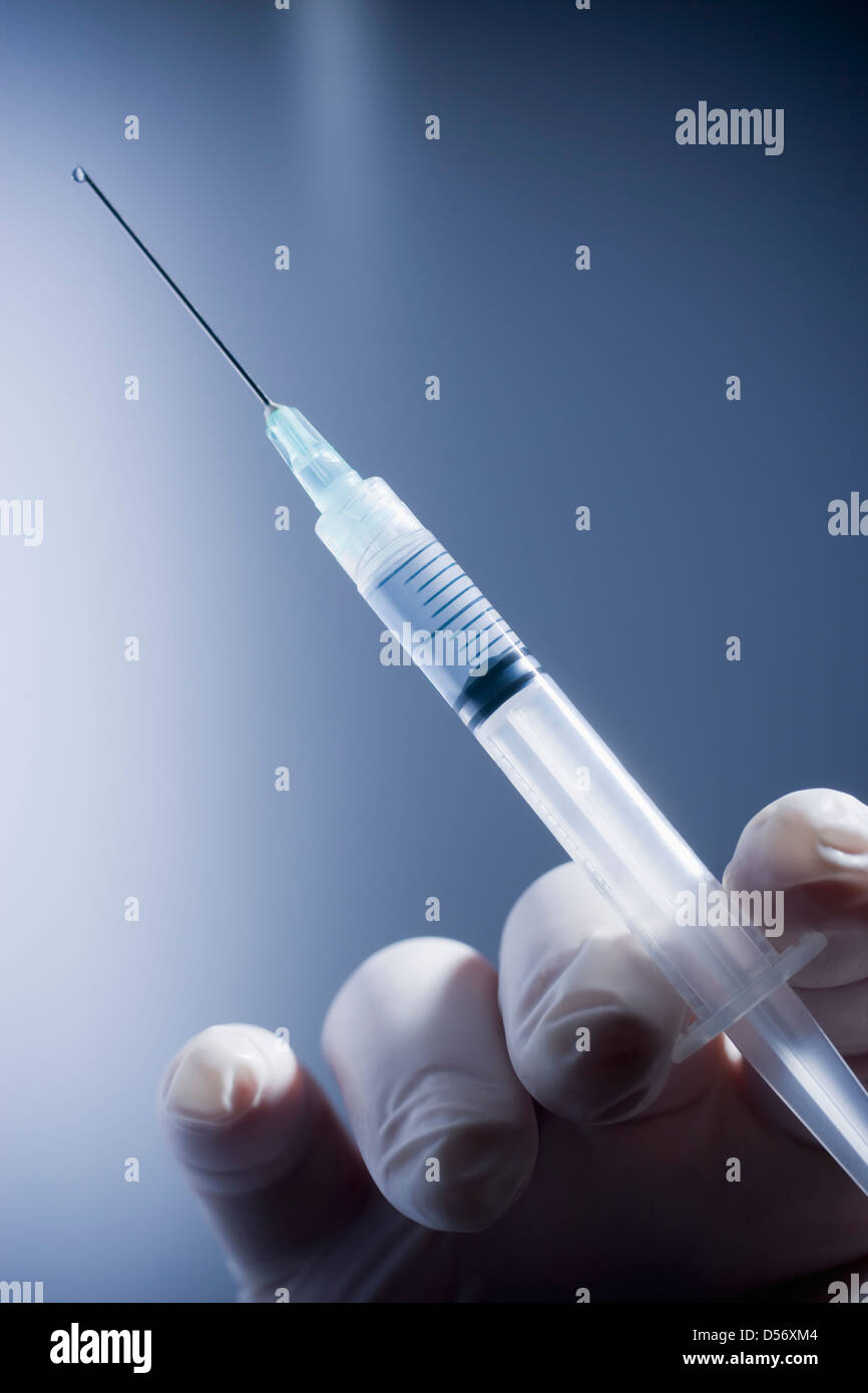Close up hand holding syringe hi-res stock photography and images - Alamy