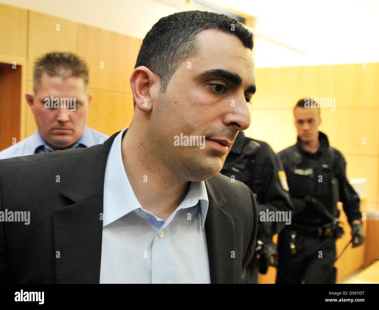 A court usher and armed police officers lead defendant Taylan K. (C ...