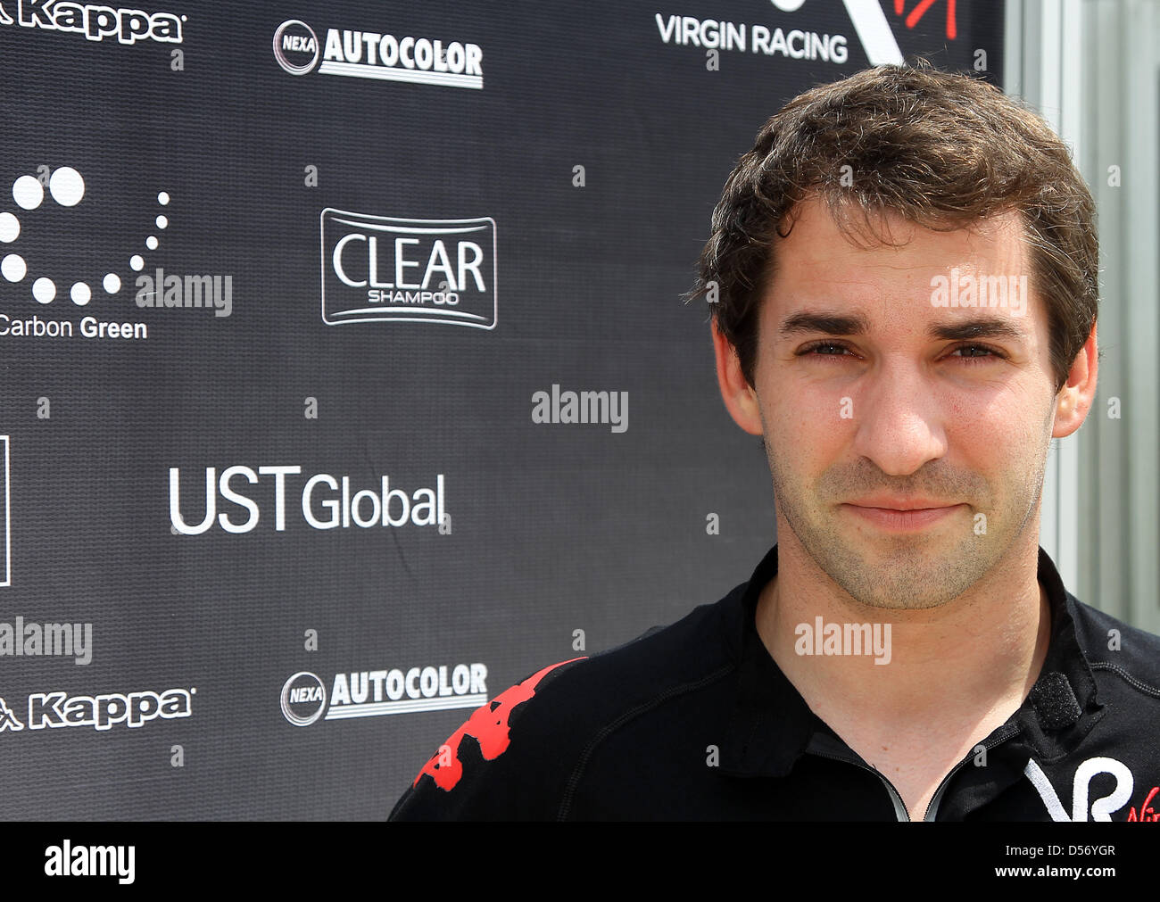 German Timo Glock of Team Virgin Racing stands in front of his motor ...