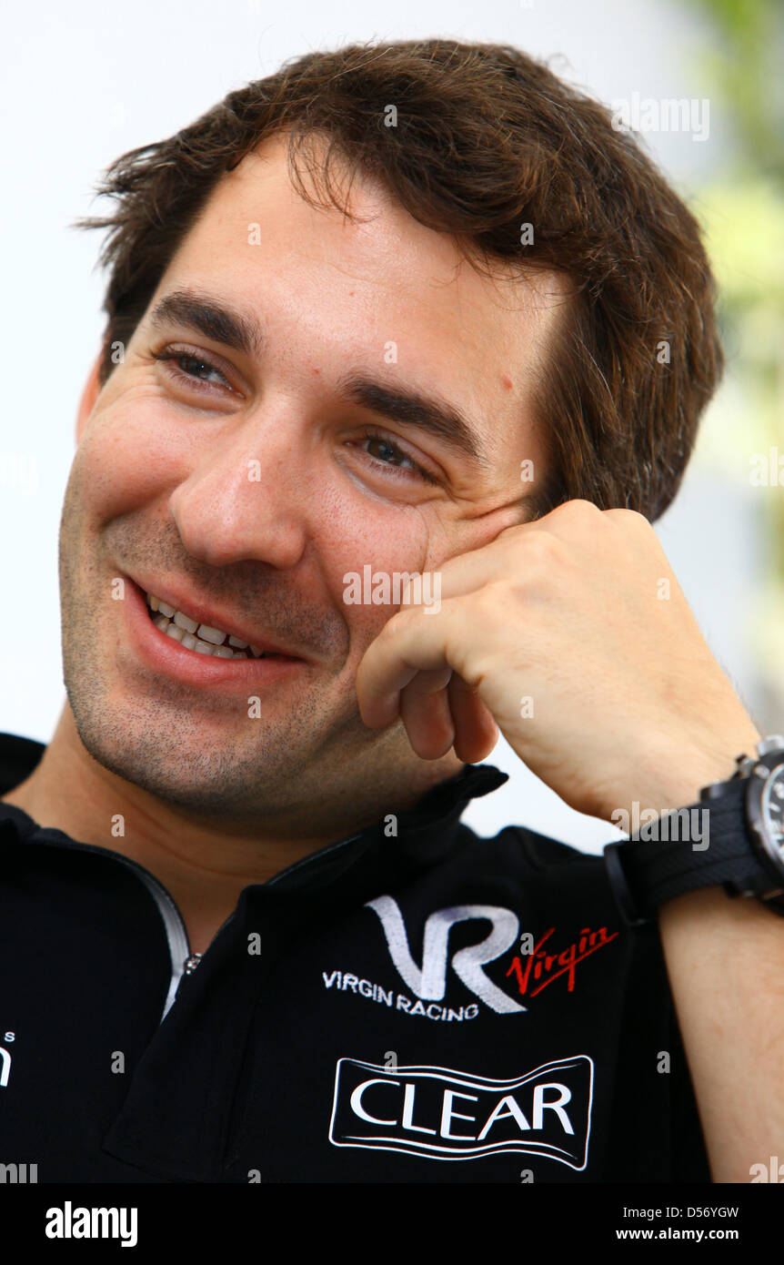 German Timo Glock of Team Virgin Racing smiles during an interview with ...