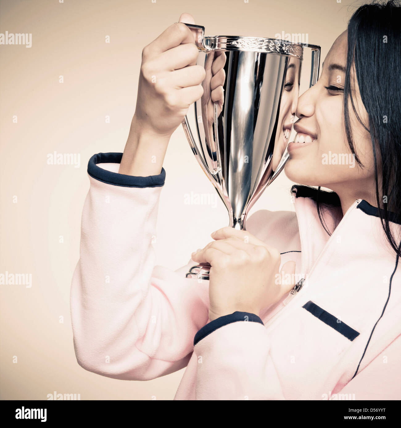 Mixed race woman holding trophy Stock Photo - Alamy