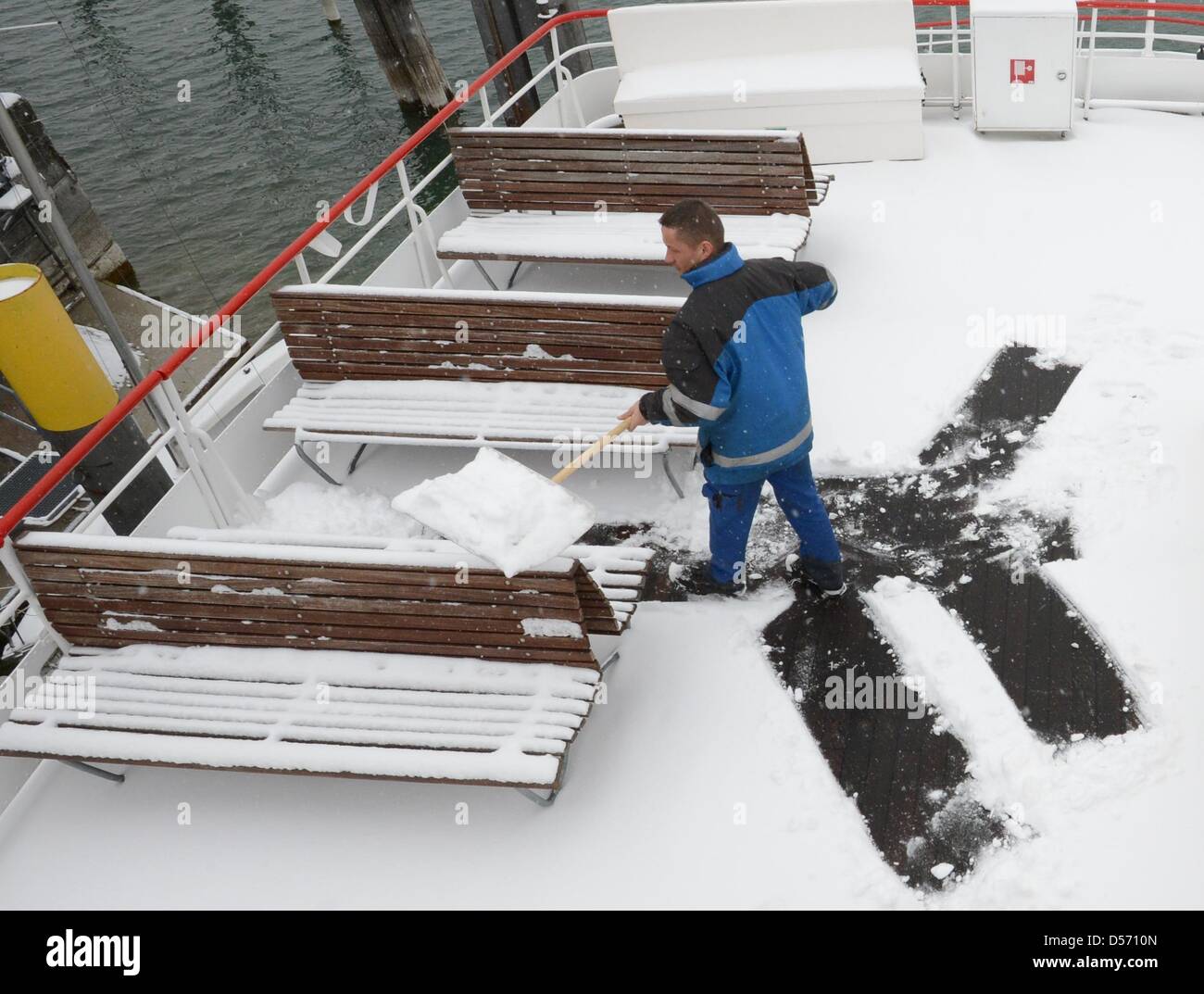 Sailor Lukas Trzeciok clears snow on deck of the ship 'MS Munich' of ...