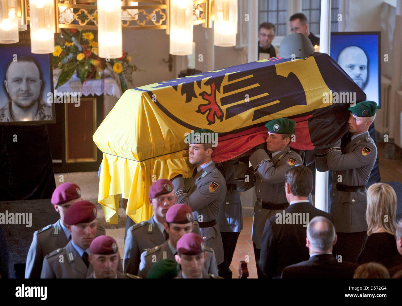 Bundeswehr soldiers carry the coffin of one of the killed comrades and ...