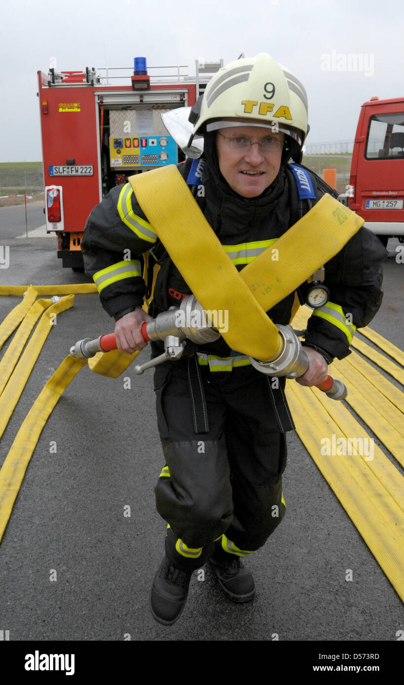 Firefighter Armin Taube pulls firehoses during the competition 'World's ...