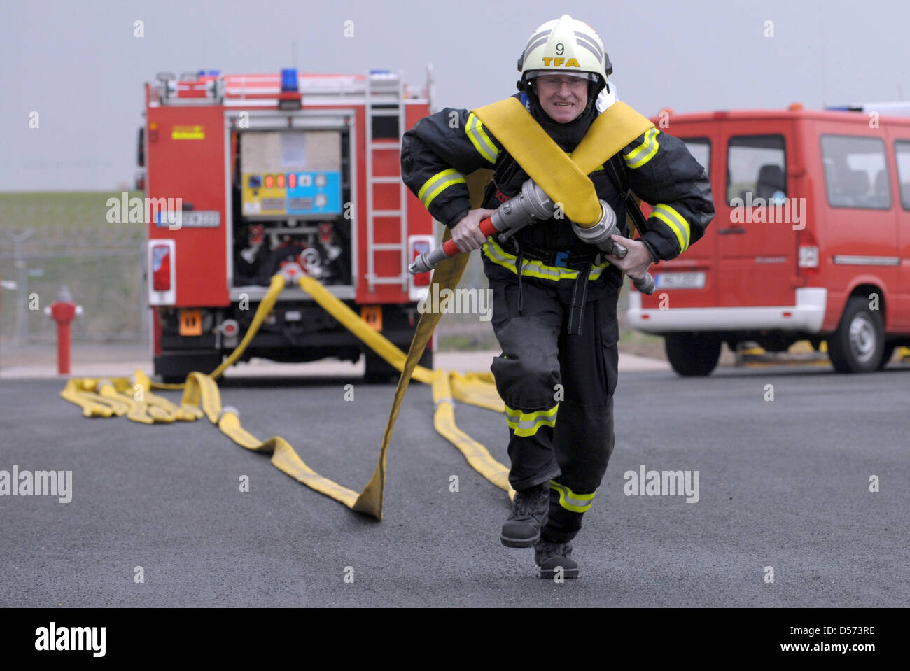 Firefighter Armin Taube pulls firehoses during the competition 'World's ...