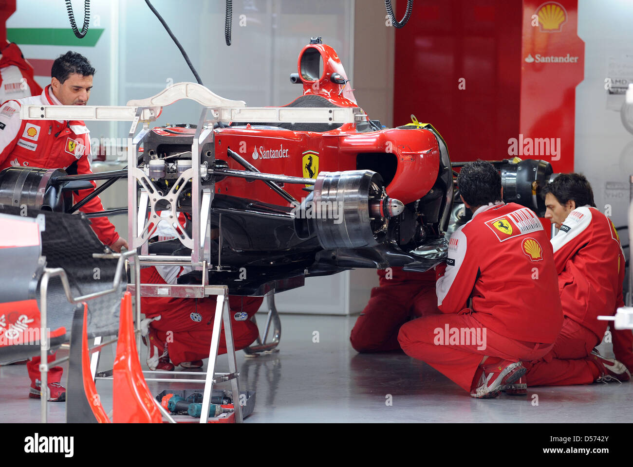 Mechanics of Ferrari work at the race car of Spanish Formula One driver ...