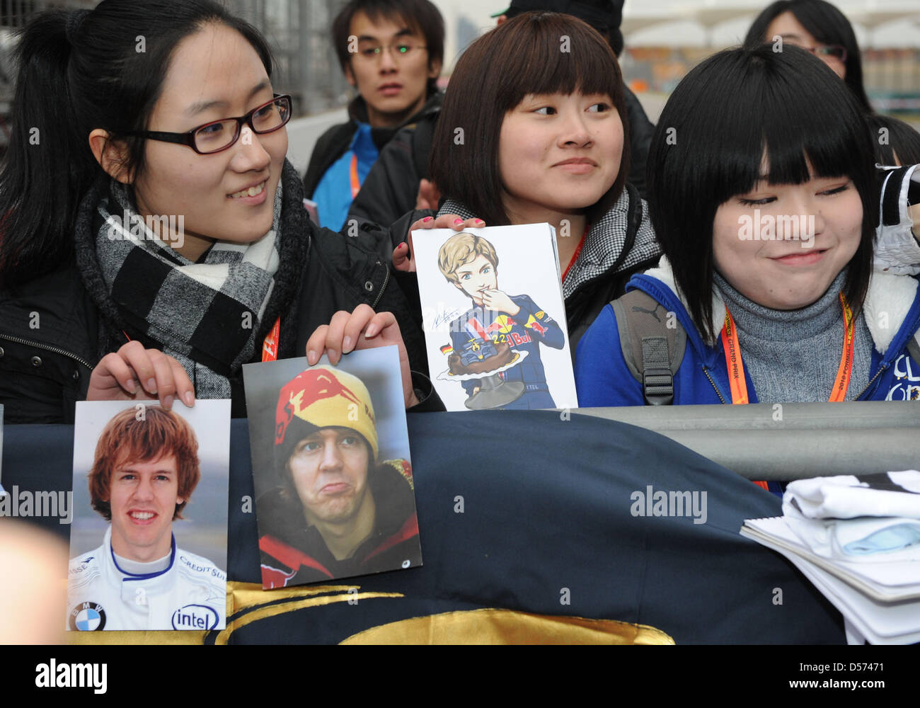 Chinese fans wait with autograph cards of German Formula One driver ...