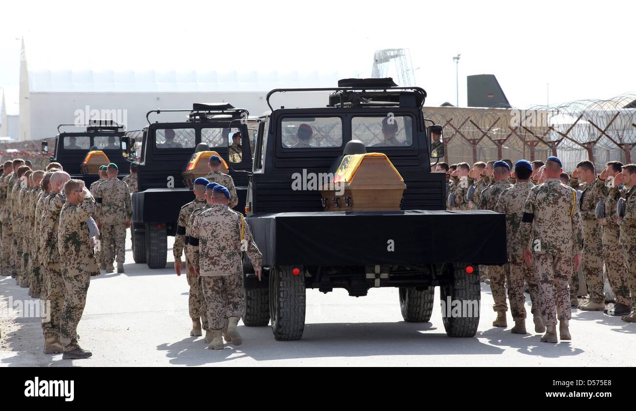 Soldiers salute and accompany the coffins of four comrades killed in ...