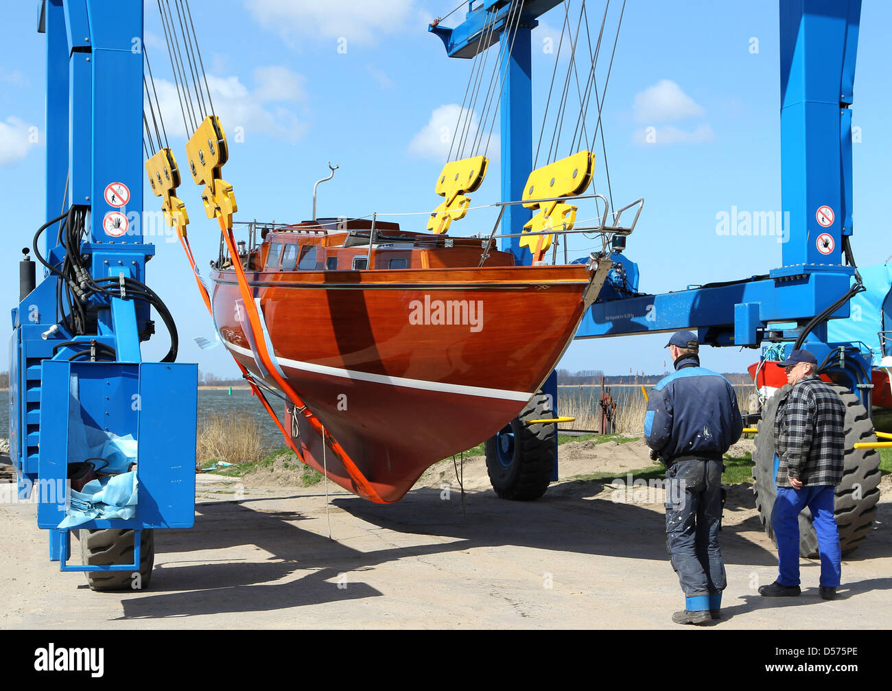 A wooden sailing boat is brought back to the waters in Barth, Germany ...