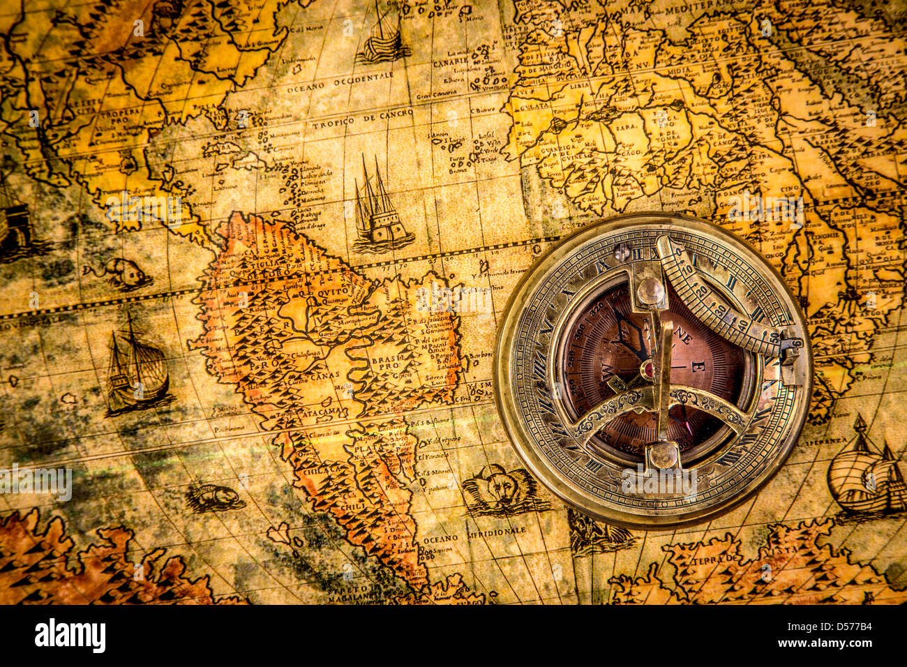 Vintage still life. Vintage compass lies on an ancient world map of ...