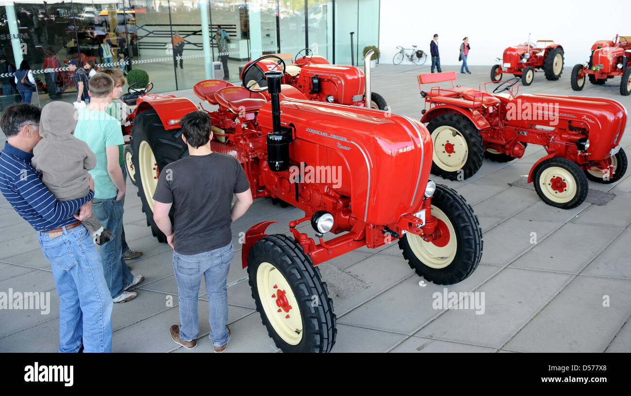 Visitors gaze at historic tractors at the Porsche museum in Stuttgart ...