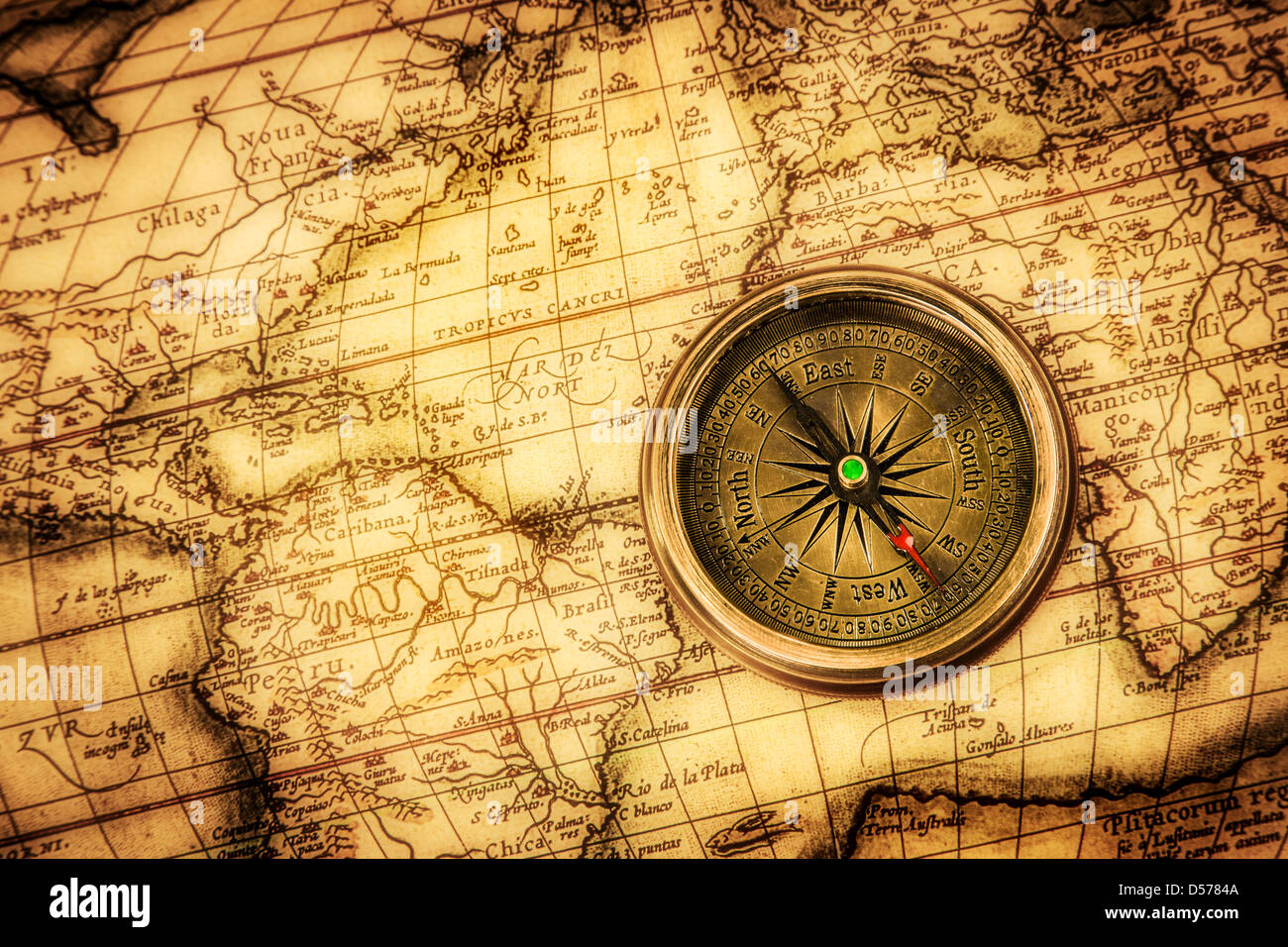 Vintage still life. Vintage compass lies on an ancient world map Stock ...