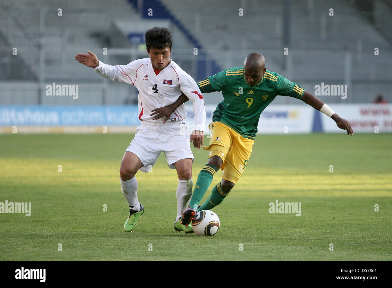 South Africa's Katlego Mphela (R) and North Korea's Pak Nam Chol vie ...