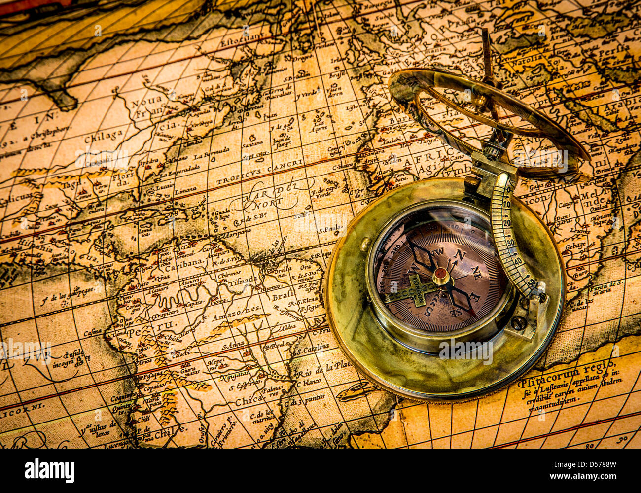 Vintage still life. Vintage compass lies on an ancient world map Stock ...