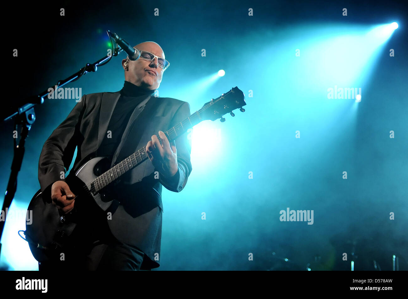 Singer Midge Ure Of The British Band Ultravox Stands On Stage At