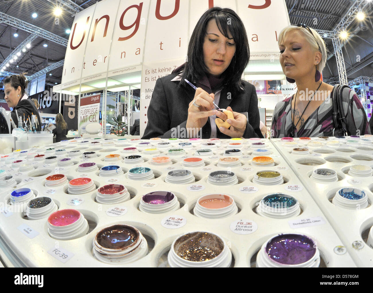 A beautician treats a visitor to cosmetics trade show Cosmetica Leipzig ...