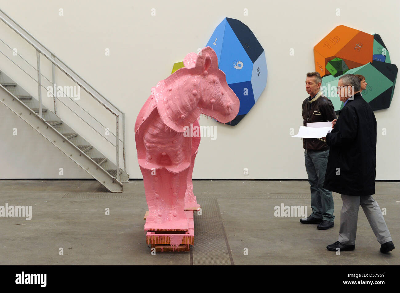 Two men look at the artpiece ''Pink Rocinante'' (enamelled bronze) by ...