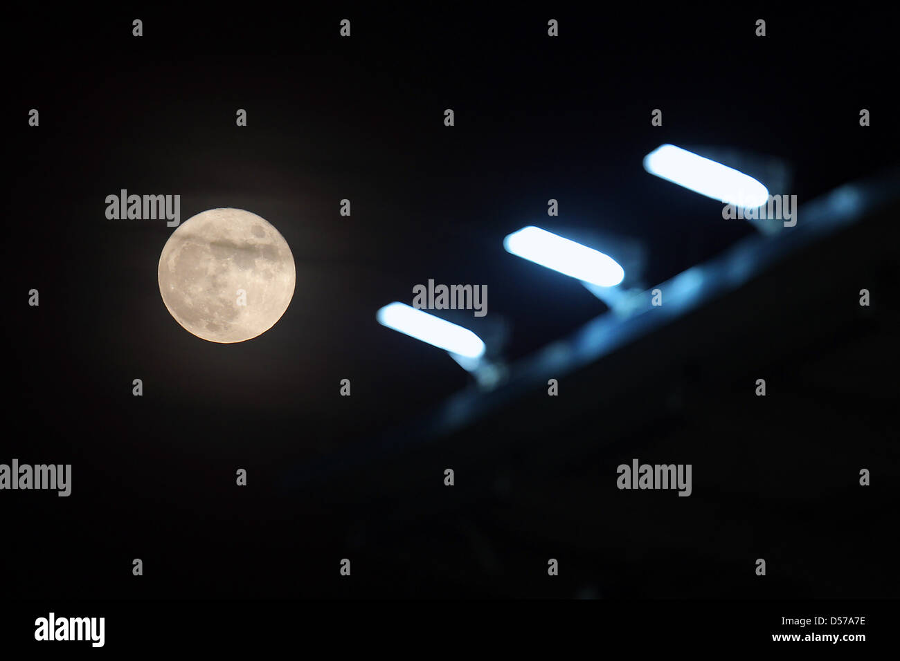 The moon shines above the stadium after the international soccer ...