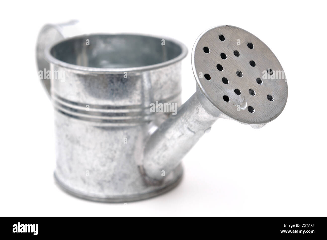 a small watering can with water drops isolated on white background ...