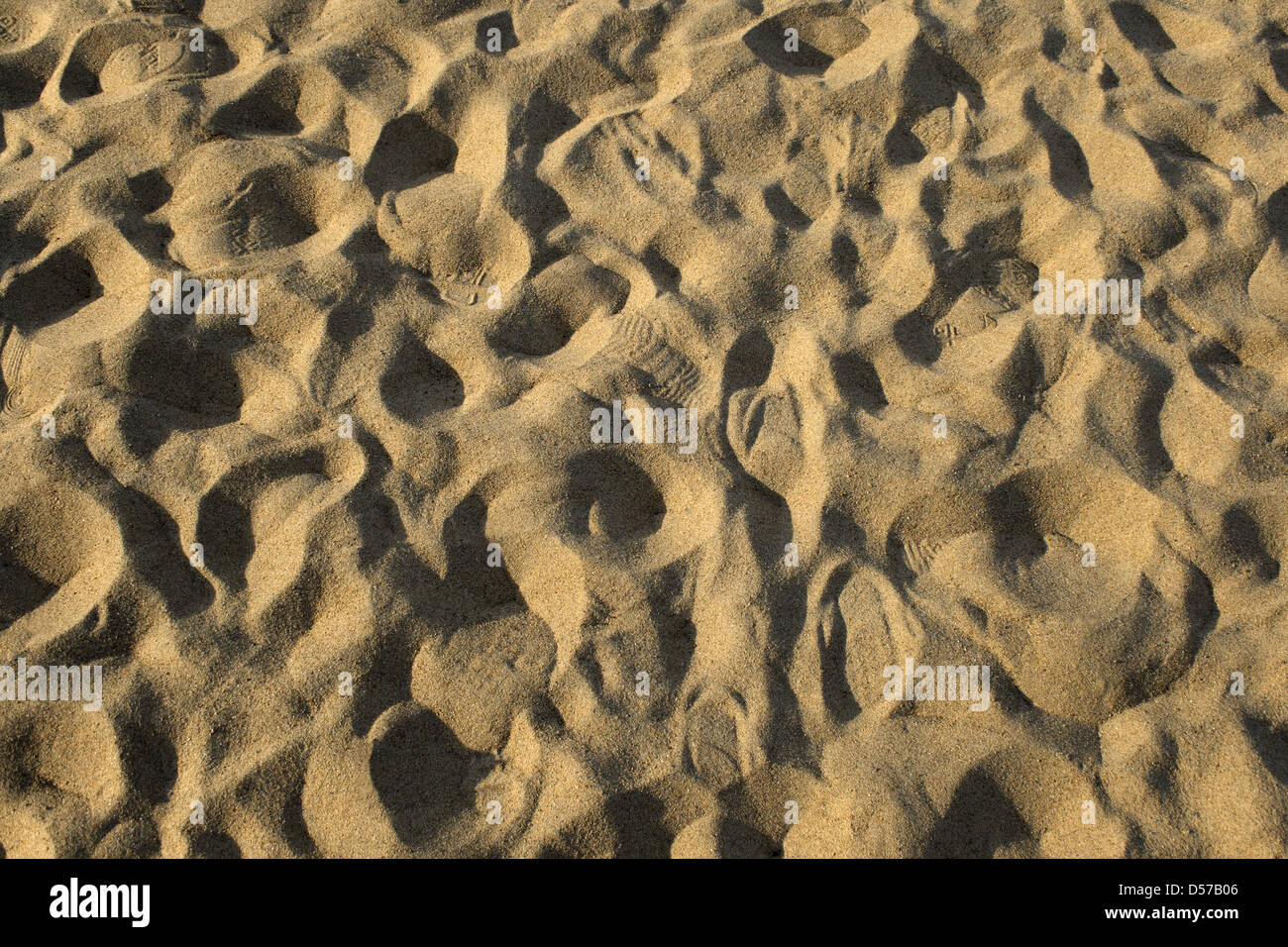 Many footprints in the sand on the beach Stock Photo - Alamy