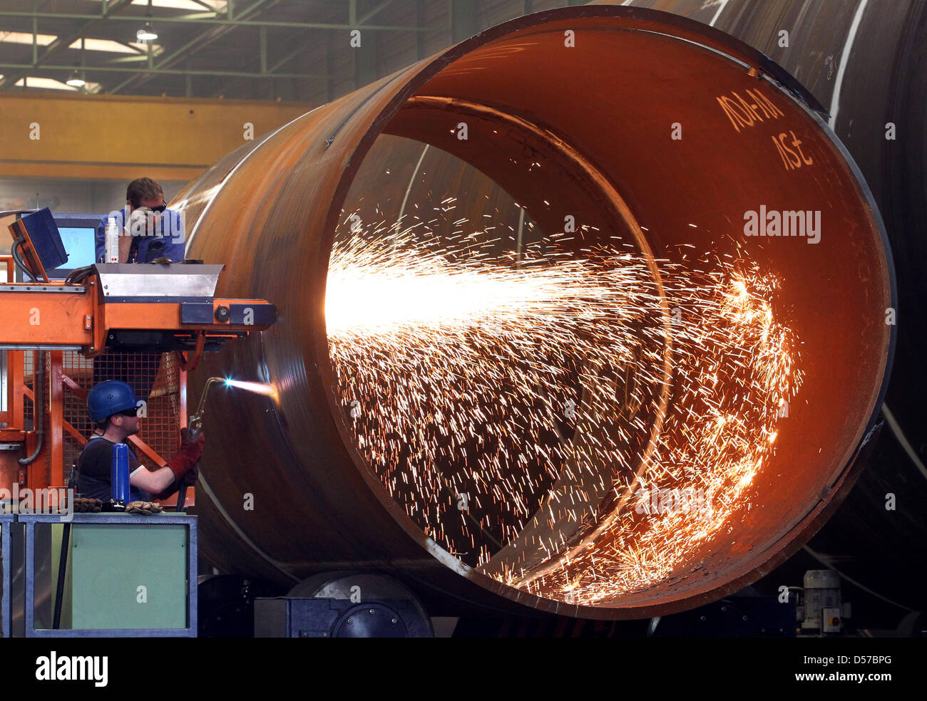 Staff members of EEW Special Pipe Conmstructions weld segments for an ...